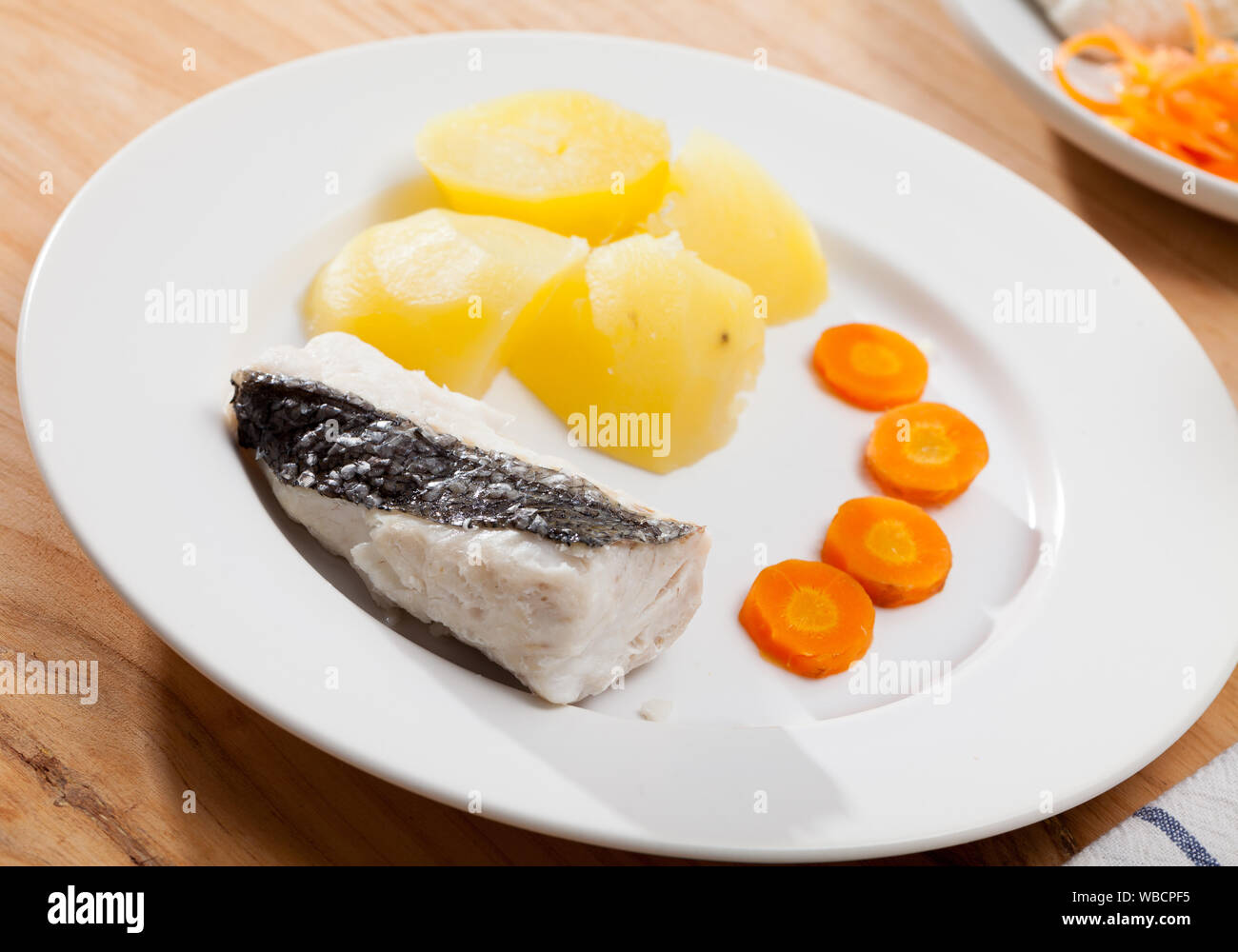 Steamed whiting fish with vegetable garnish of cooked potato and ...