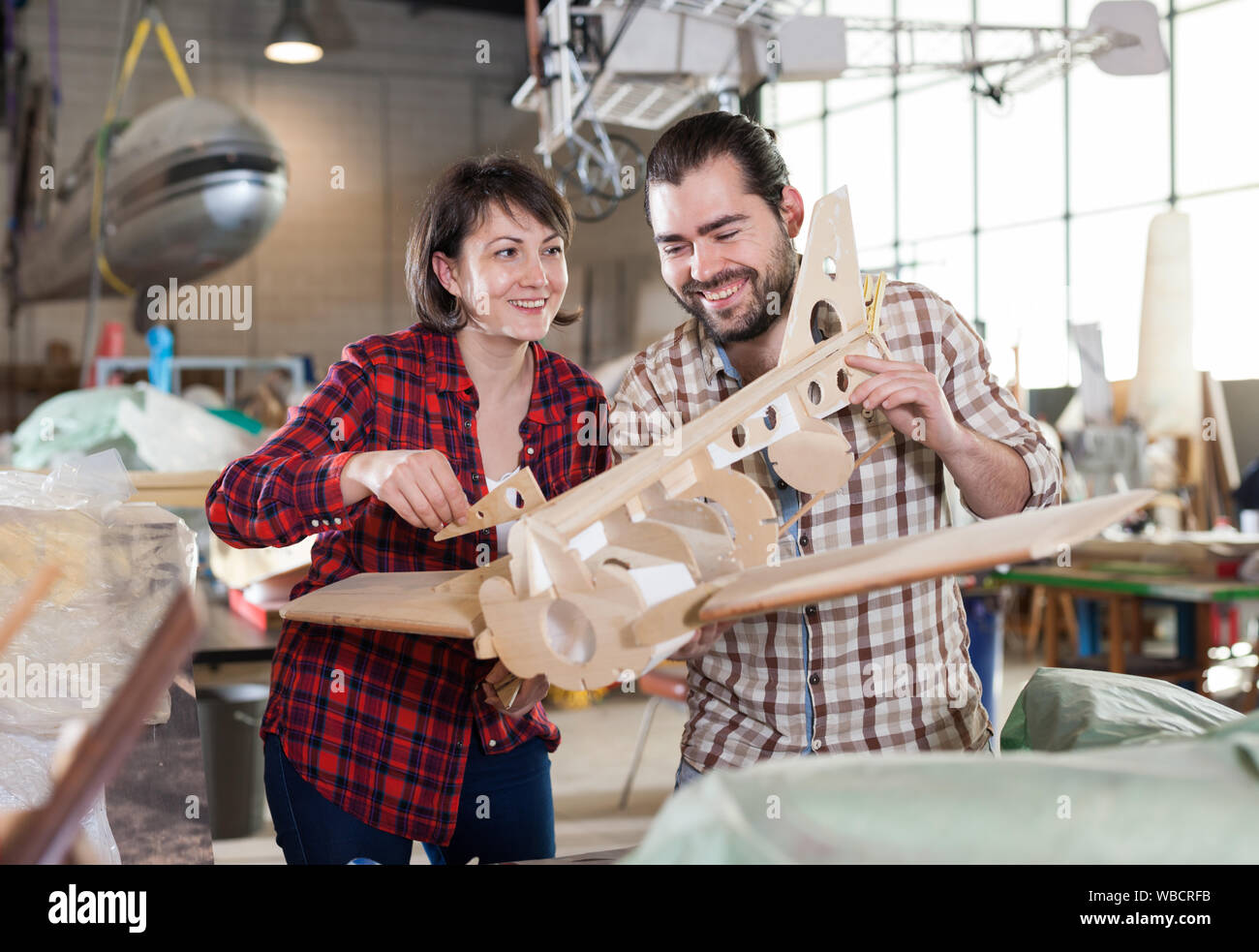 Positive couple enjoying their hobbies - modeling light airplanes in ...