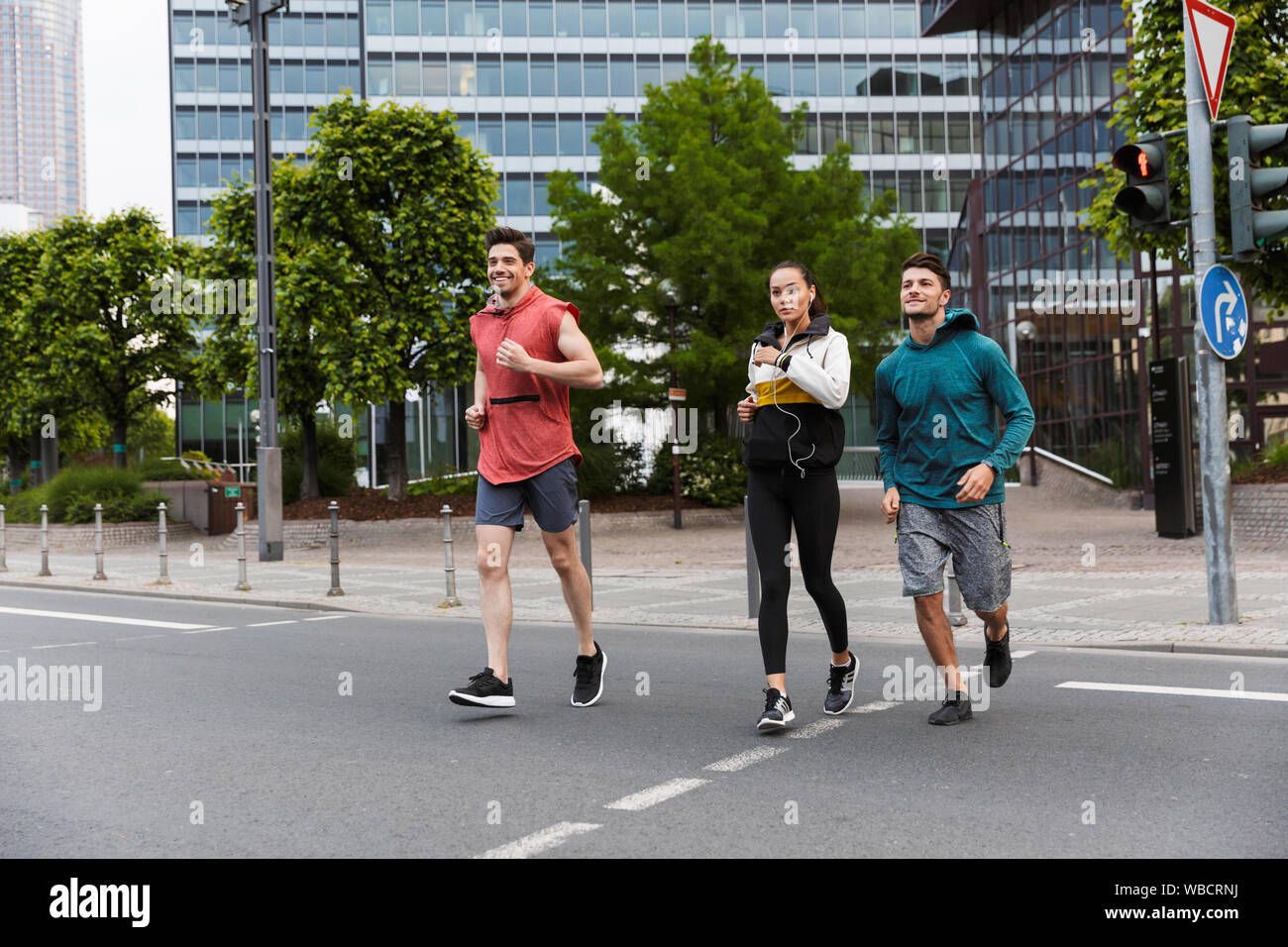 Photo of athletic young people wearing sportswear doing workout and ...