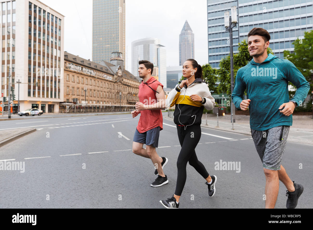 Photo of athletic young people wearing sportswear doing workout and ...
