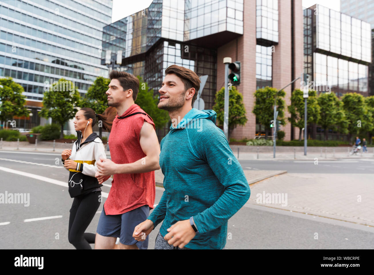 Photo of athletic concentrated people wearing sportswear doing workout ...