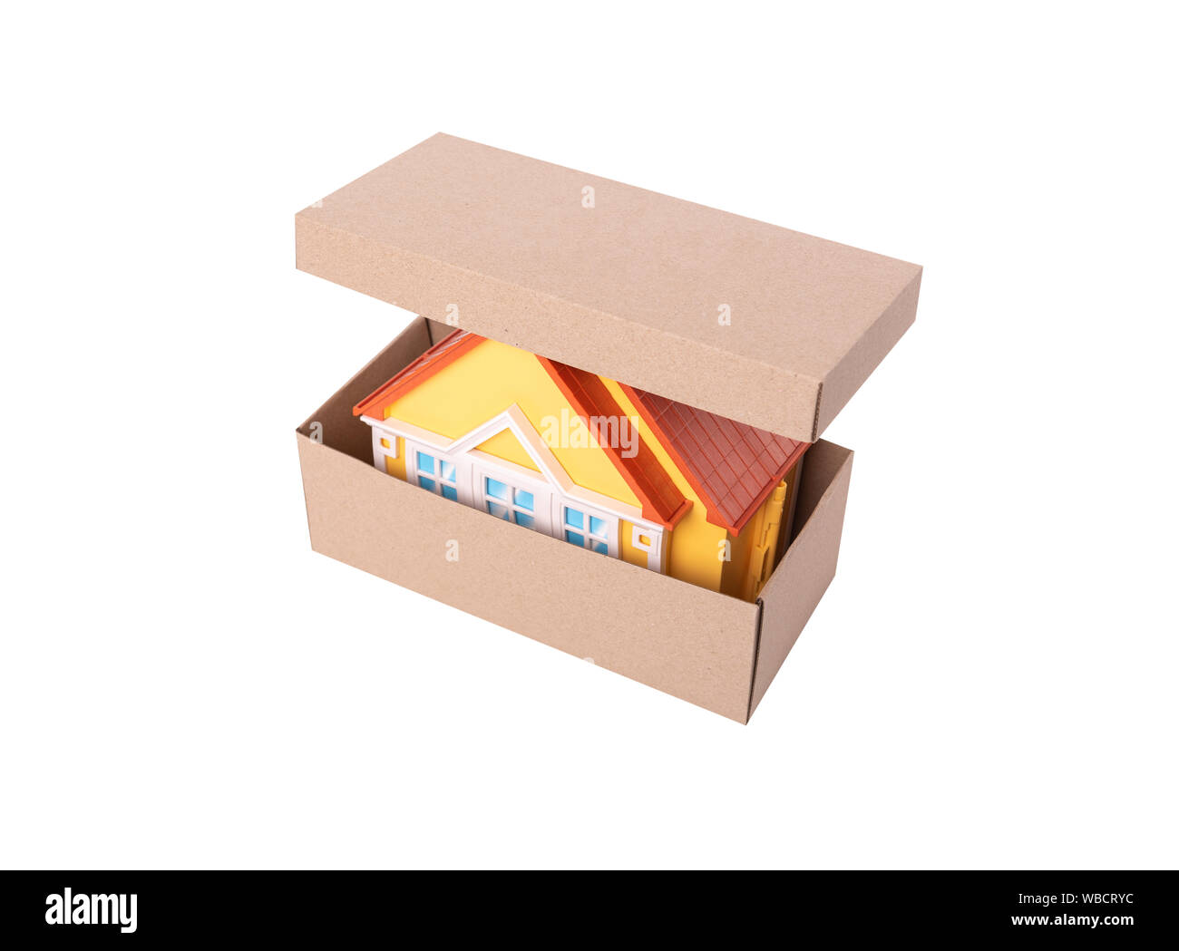 Toy model of a house in a cardboard box on white background Stock Photo ...
