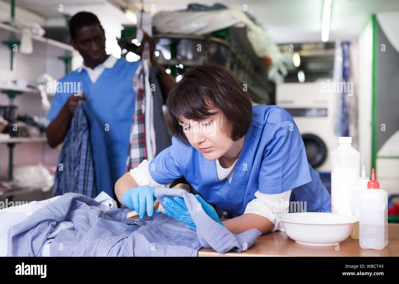 Woman sorting laundry in modern hi-res stock photography and images - Alamy