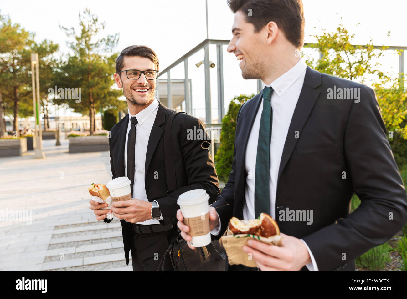 Business man eating snack walking hi-res stock photography and images ...