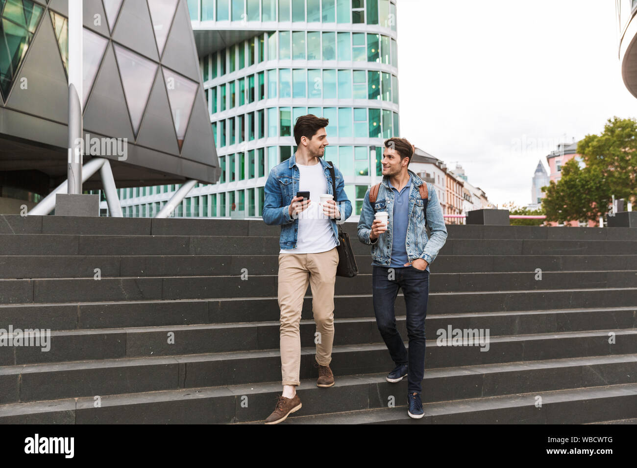 Two men walking down staircase hi-res stock photography and images - Alamy