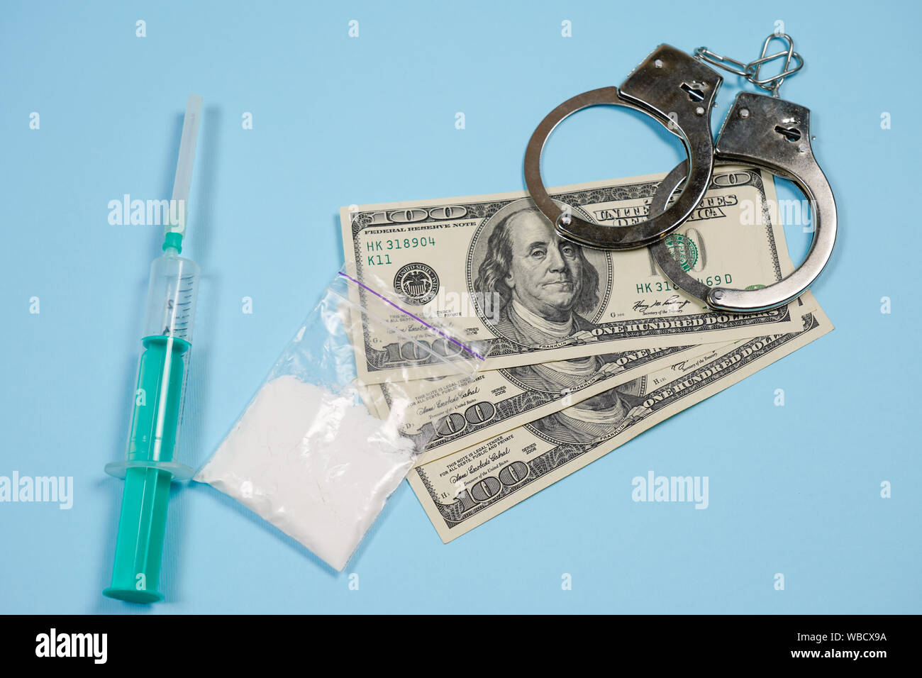A bag of drugs, US dollars and handcuffs on the table Stock Photo - Alamy