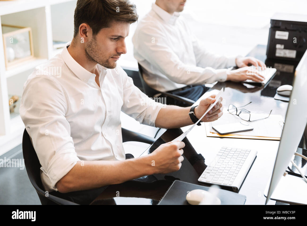 Men holding documents hi-res stock photography and images - Alamy