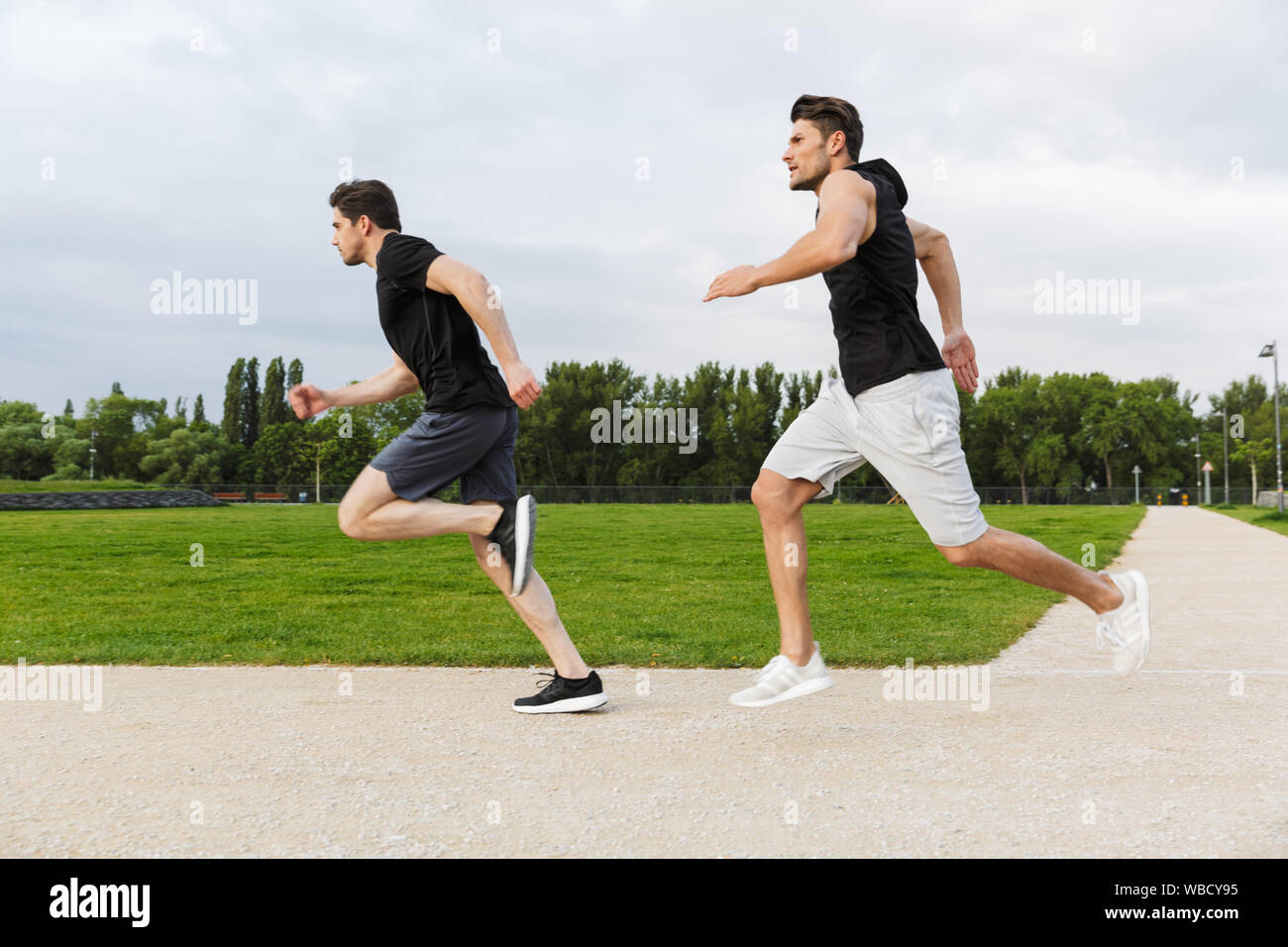 Image of two athletic guys in sportswear working out and running at at ...