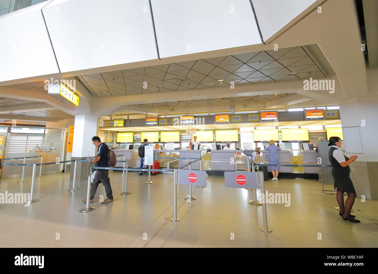 People check in at Lufthansa cheek in counter Berlin Tegel airport ...