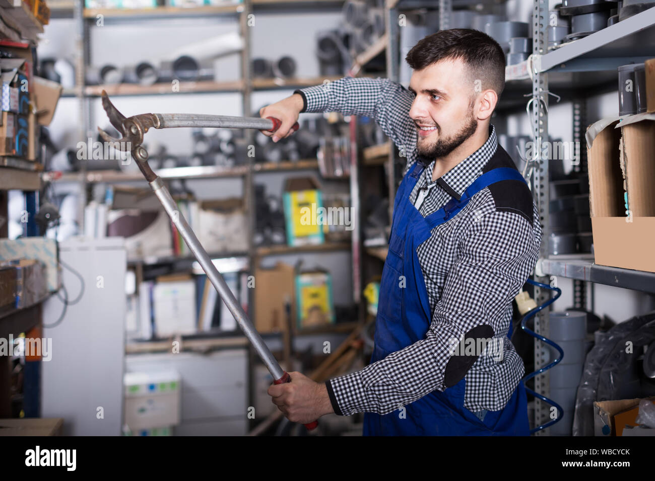 Young builder shows how to properly use the pruner in a workshop Stock ...