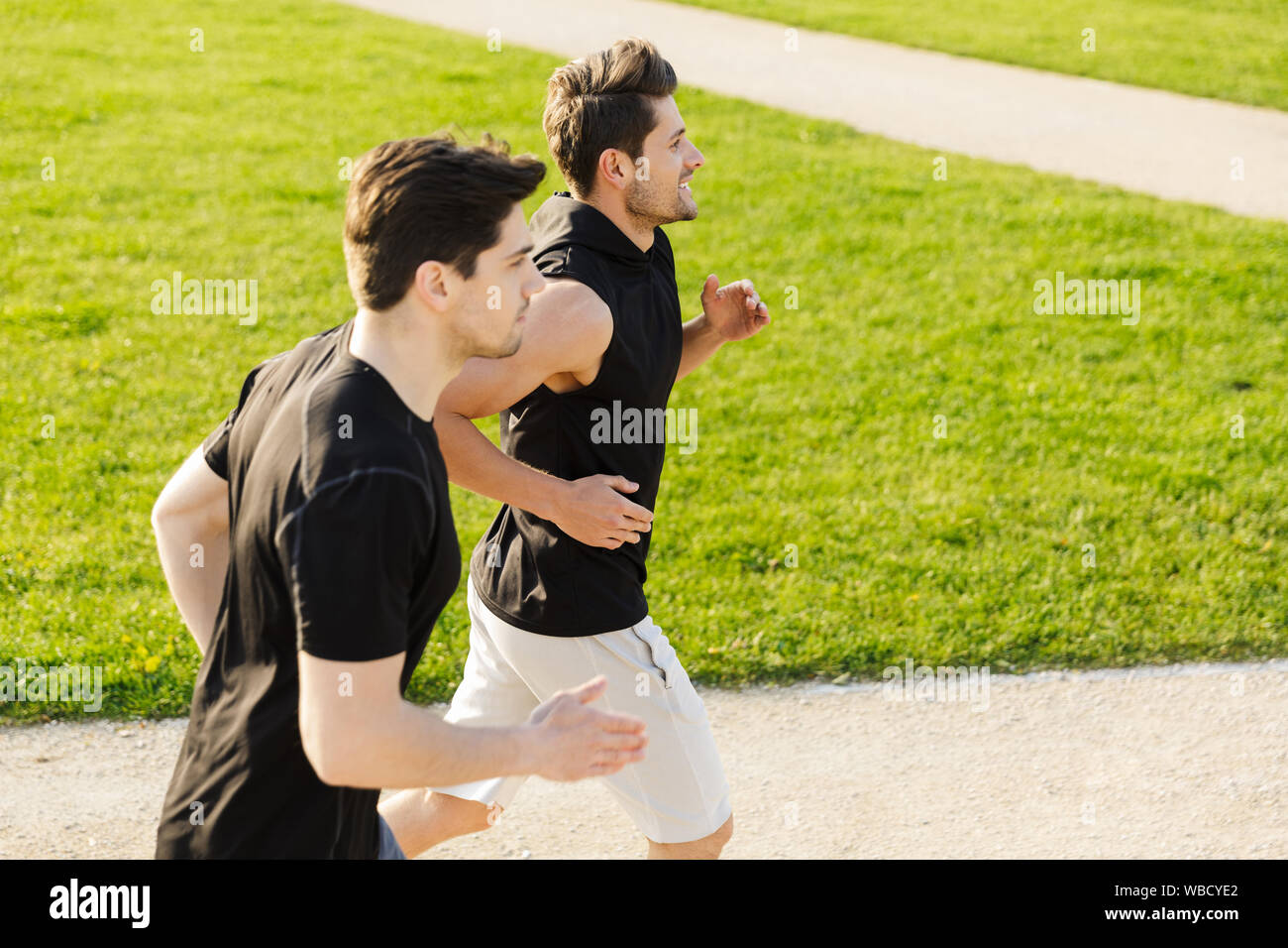 Image of two masculine men in sportswear working out and running at at ...