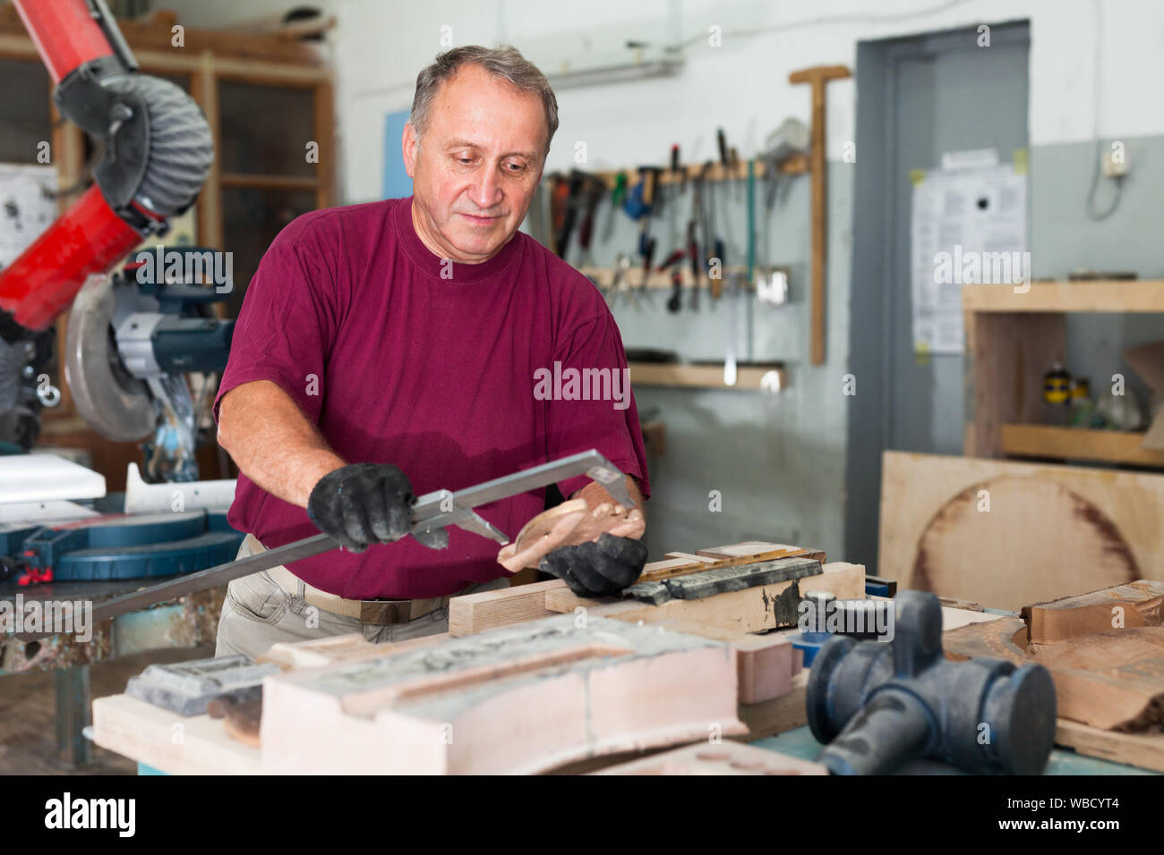 Foreman checks 3d model with a caliper Stock Photo - Alamy