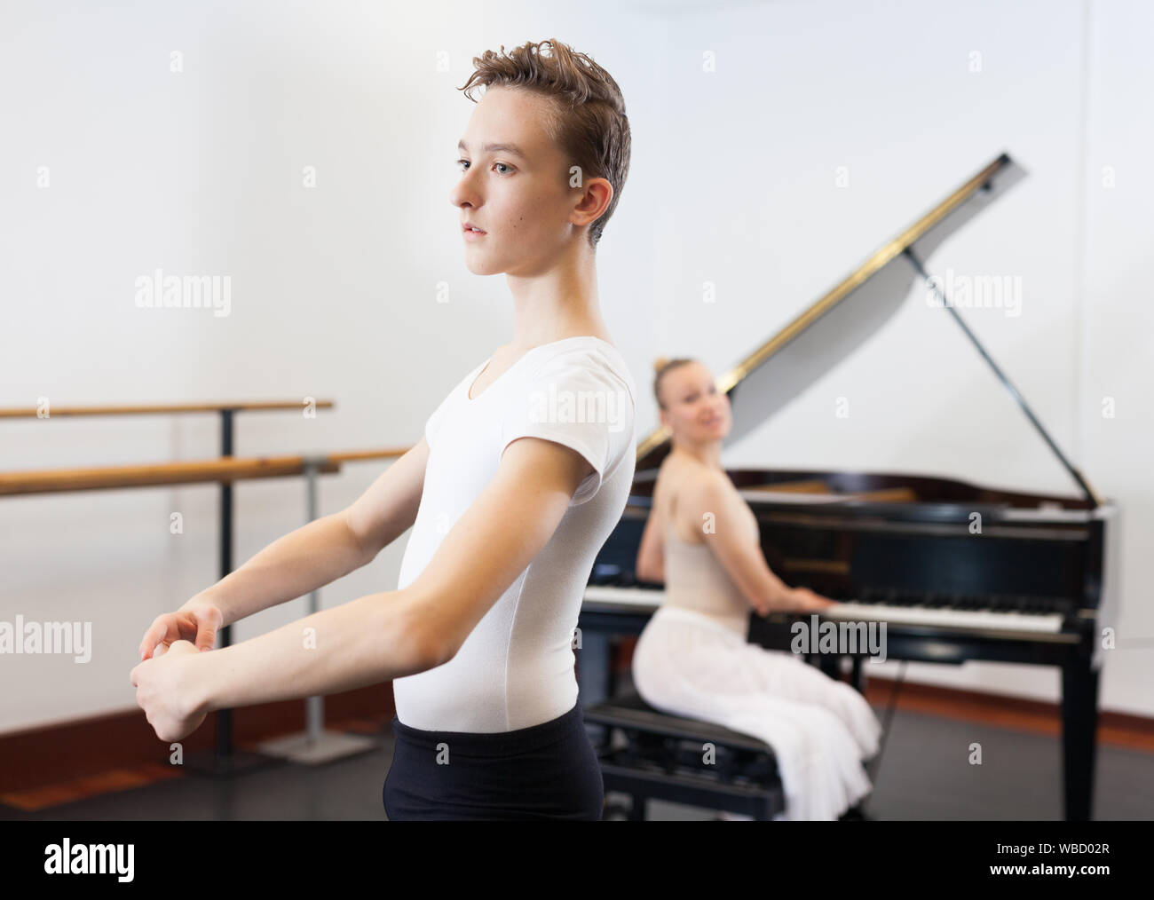 Ballet lesson in the studio. Choreographer plays the piano Stock Photo ...