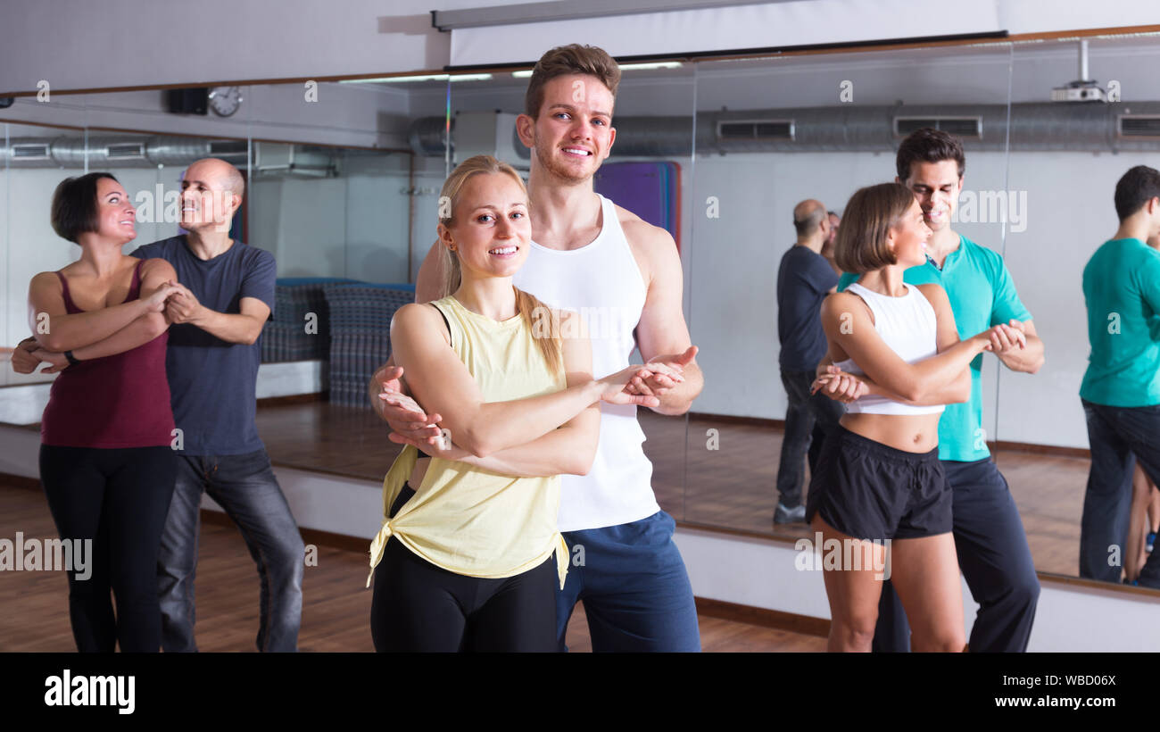 Young sporty women and men learning salsa steps Stock Photo - Alamy