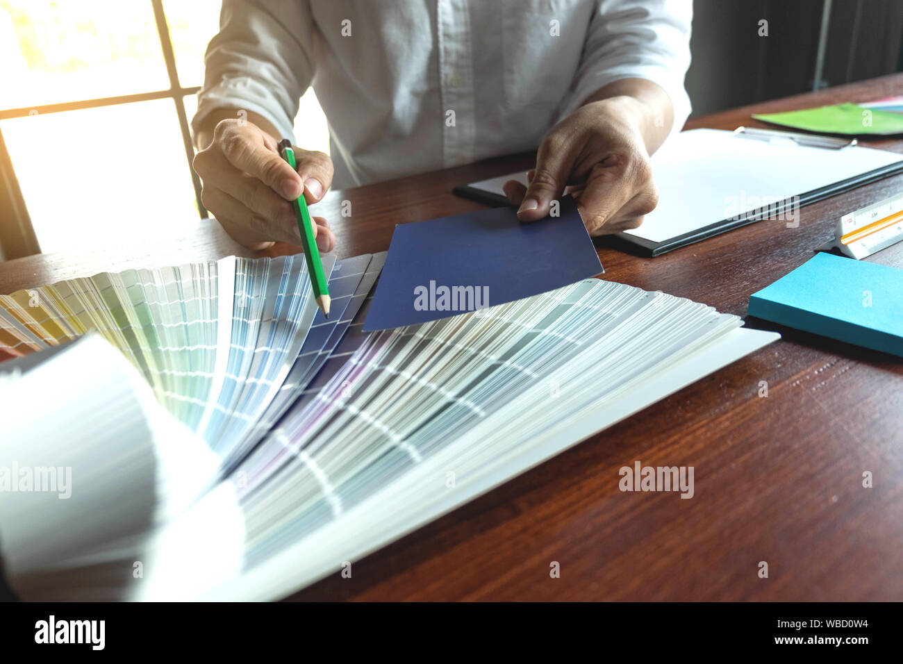 Graphic designer choose colors from the color bands samples for design ...