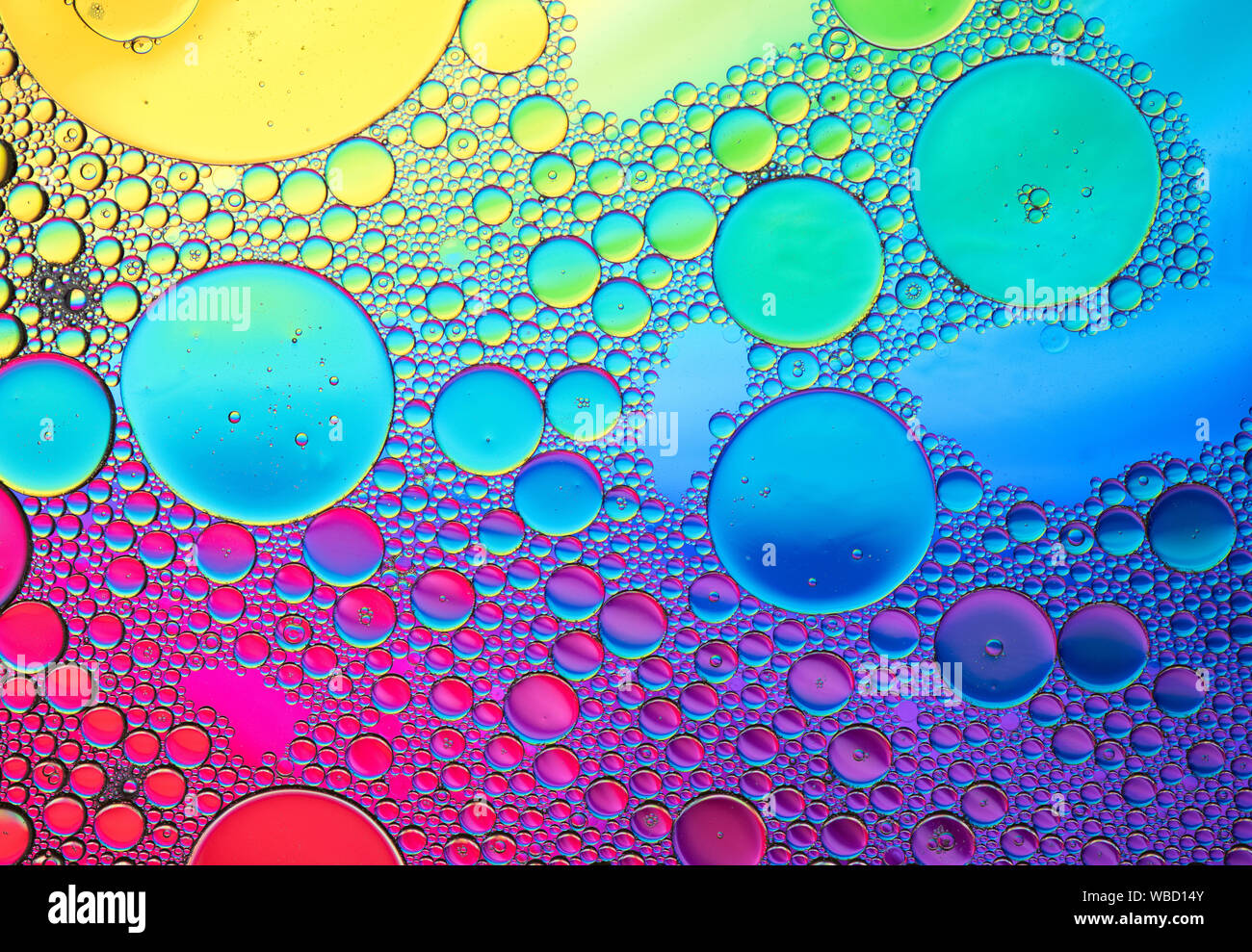 Multi-coloured bubble patterns formed by oil floating on water Stock ...