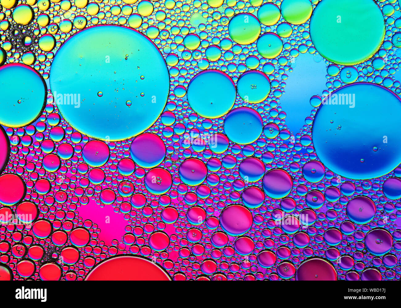 Multi-coloured bubble patterns formed by oil floating on water Stock ...