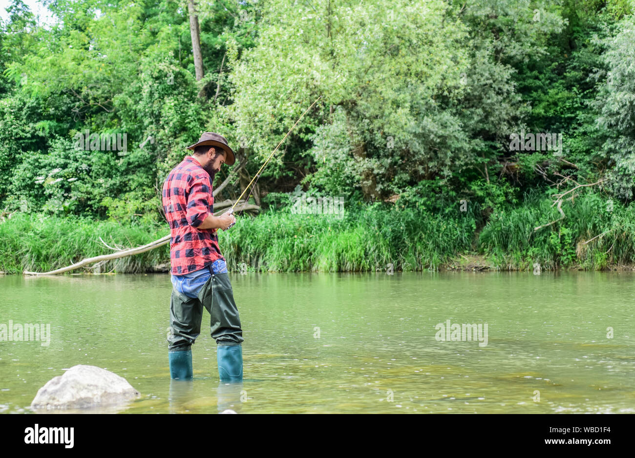 Fisherman alone stand in river water. Man bearded fisherman. Fisherman ...