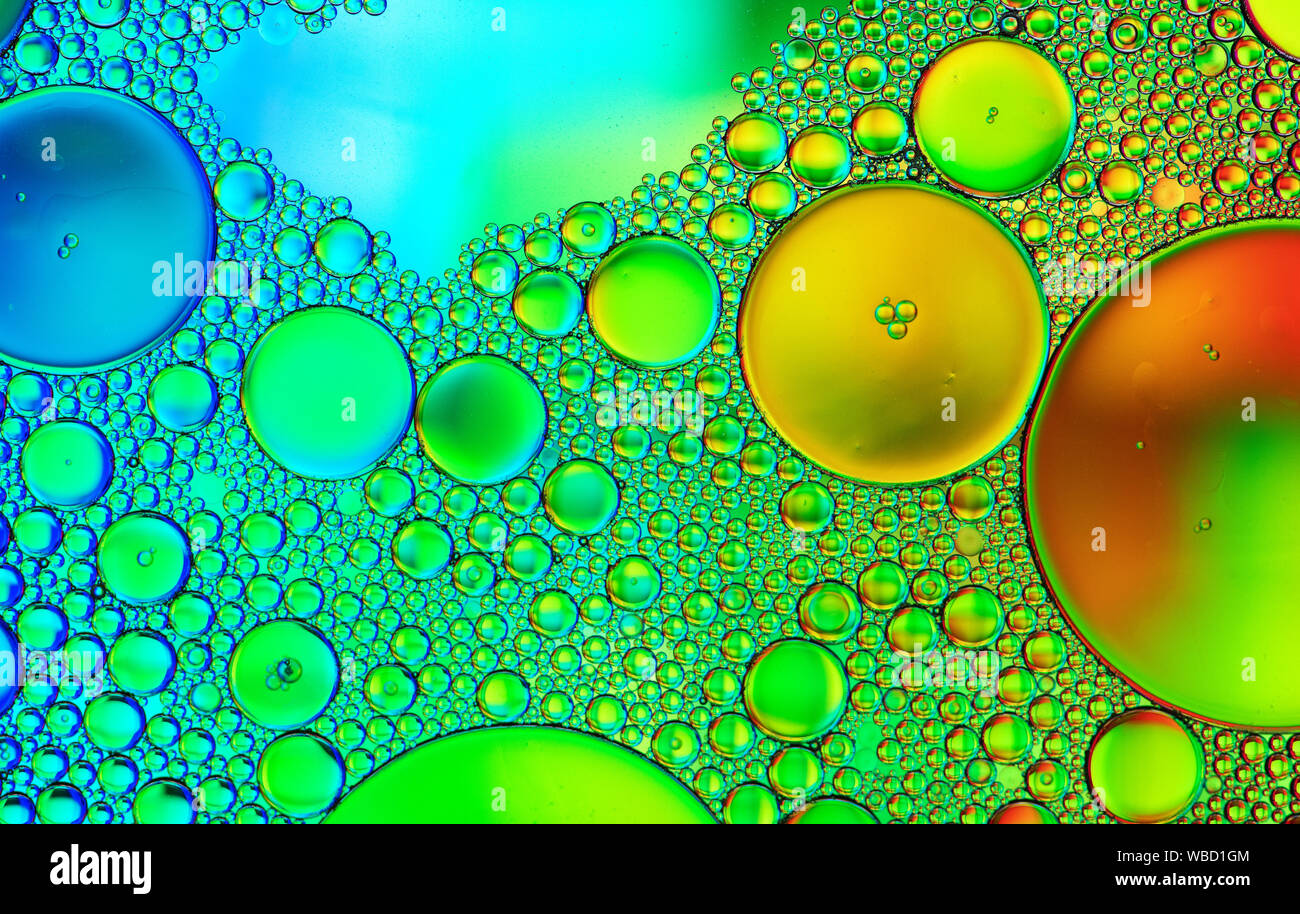 Multi-coloured bubble patterns formed by oil floating on water Stock ...