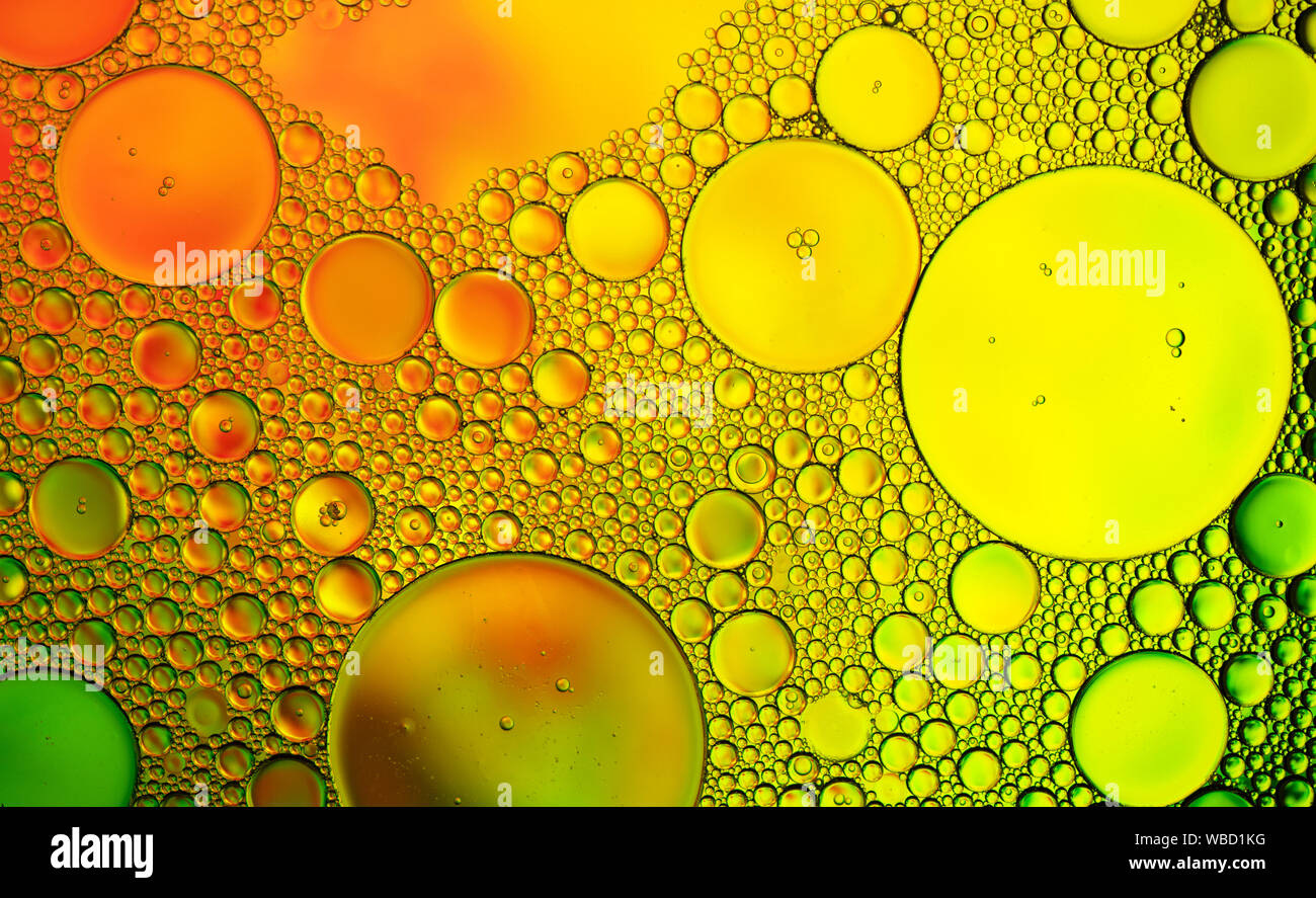 Multi-coloured bubble patterns formed by oil floating on water Stock ...