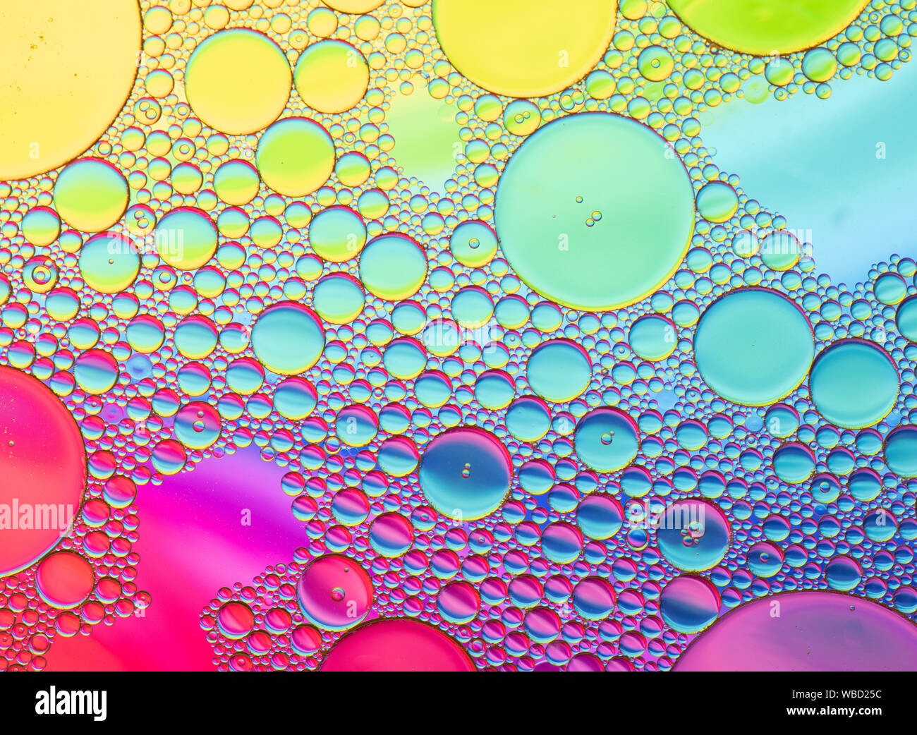 Multi-coloured bubble patterns formed by oil floating on water Stock ...