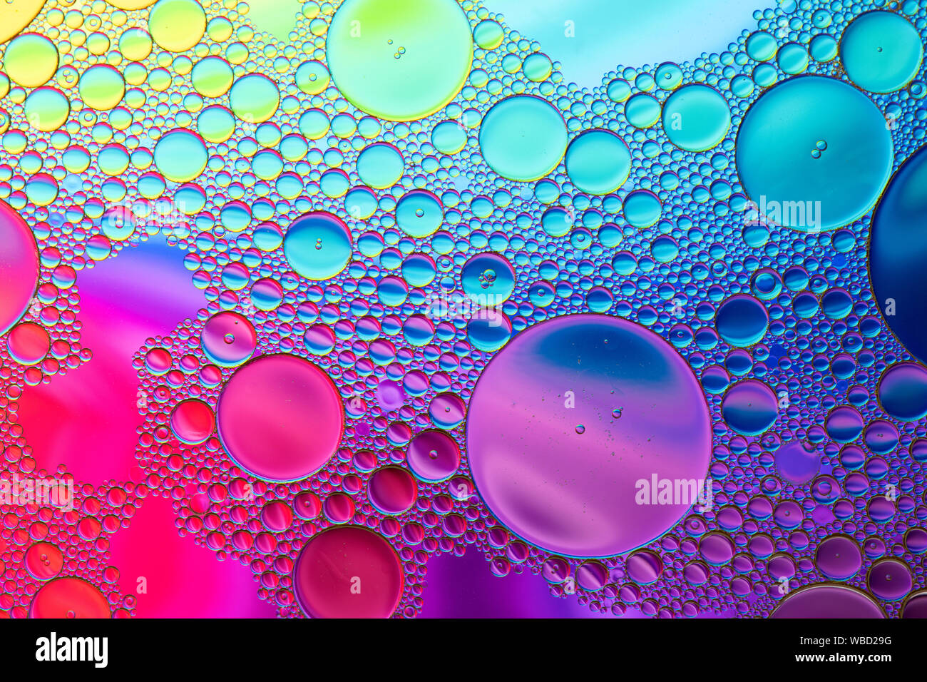 Multi-coloured bubble patterns formed by oil floating on water Stock ...