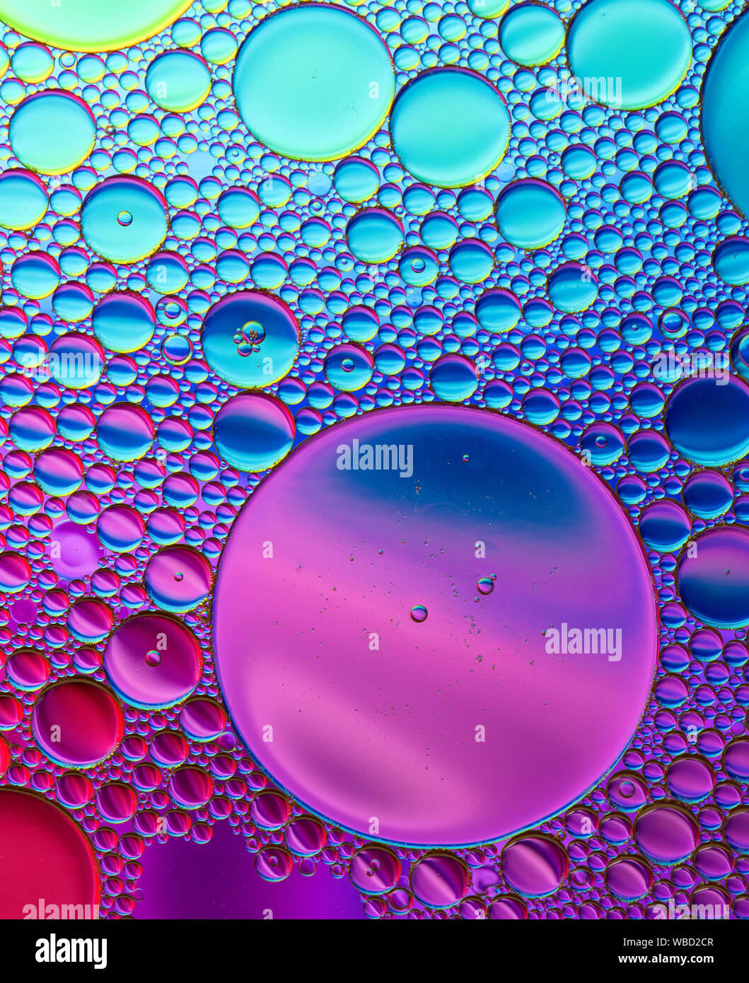 Multi-coloured bubble patterns formed by oil floating on water Stock ...