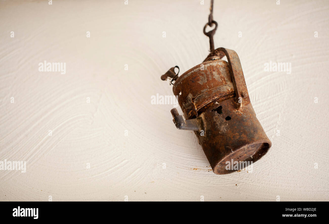 old rusty mining lamp on the white wall Stock Photo - Alamy