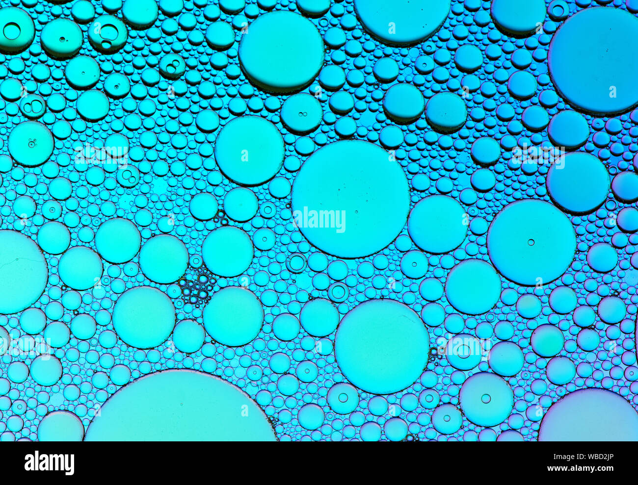 Multi-coloured bubble patterns formed by oil floating on water Stock ...