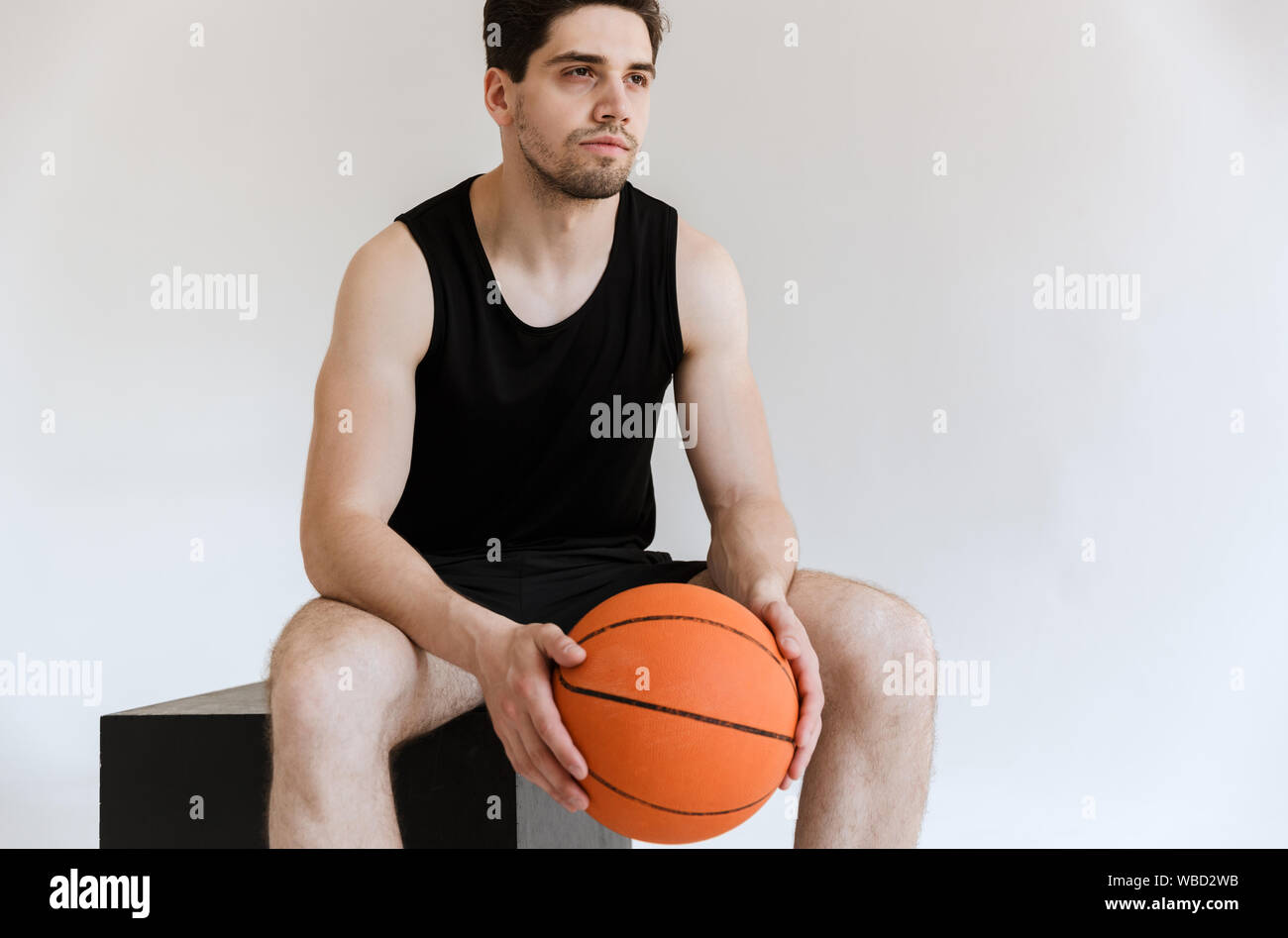Photo of a handsome concentrated strong young sports man basketball ...