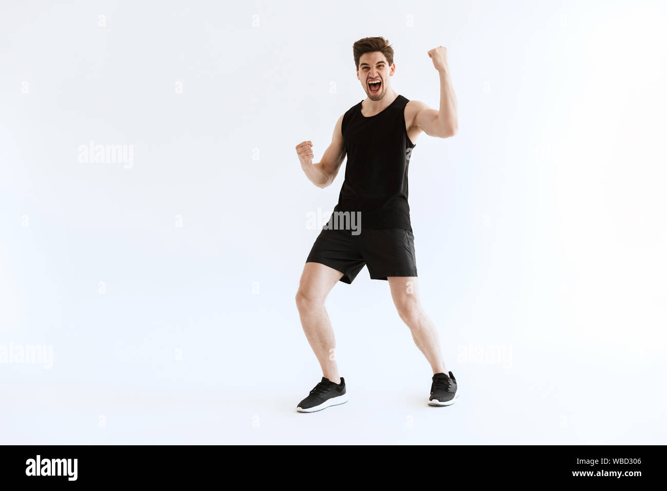 Image of a screaming positive young sports man running isolated over ...