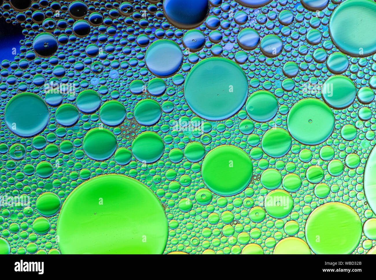 Multi-coloured bubble patterns formed by oil floating on water Stock ...