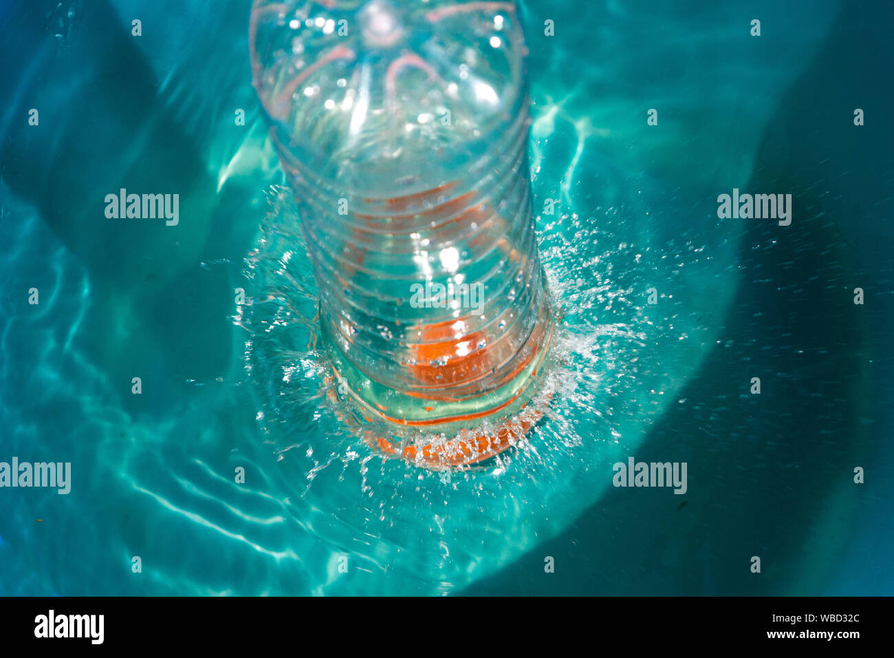 plastic bottle falling into the water making a big spray Stock Photo ...