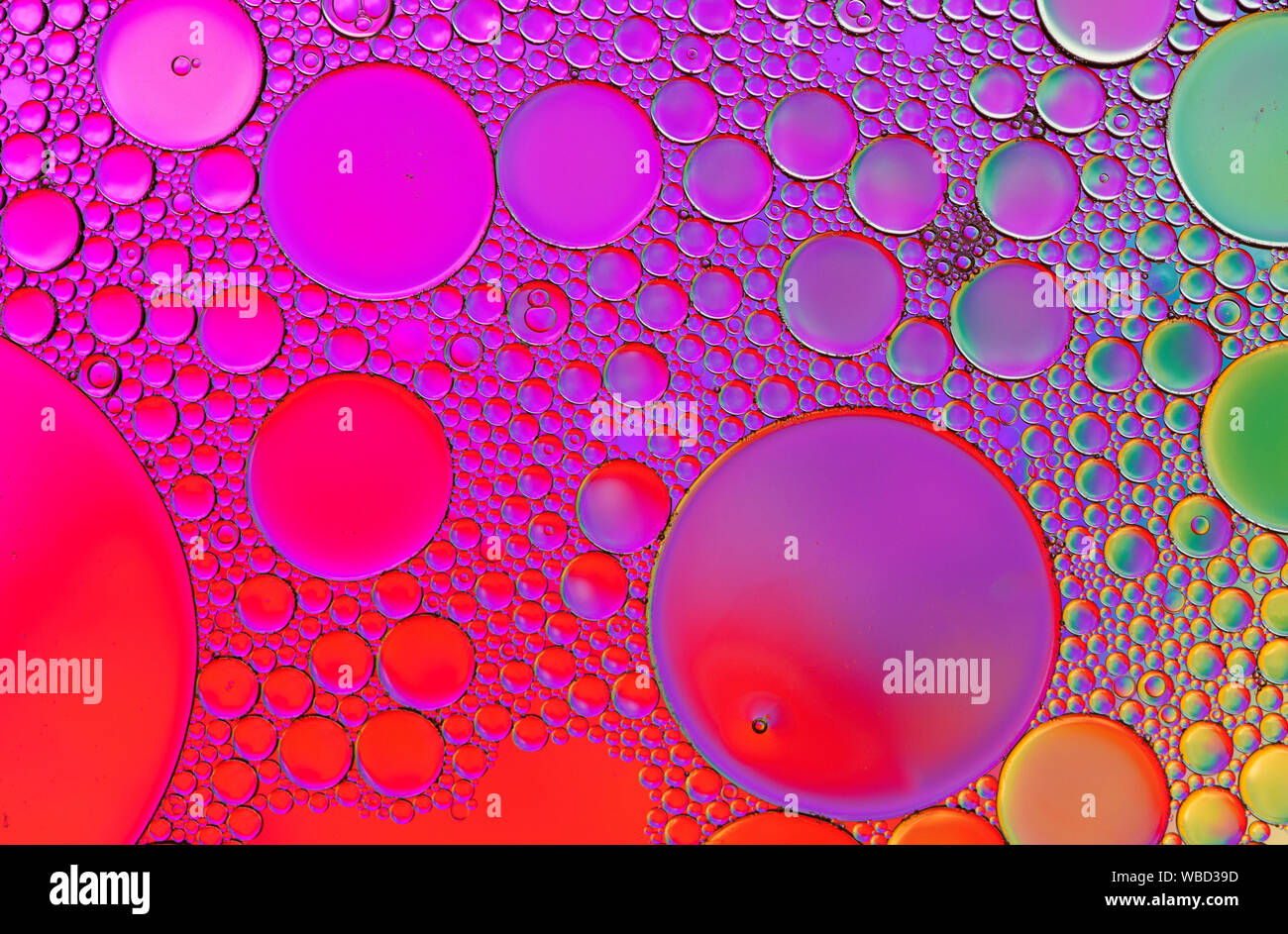 Multi-coloured bubble patterns formed by oil floating on water Stock ...