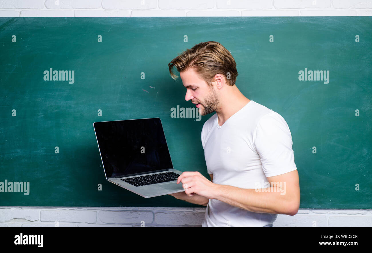 Programming web development. School teacher programming with laptop ...