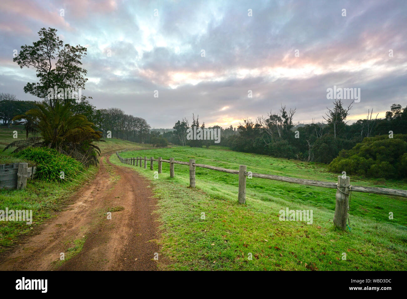 Landscape of a country farm land with a cottage at the background ...