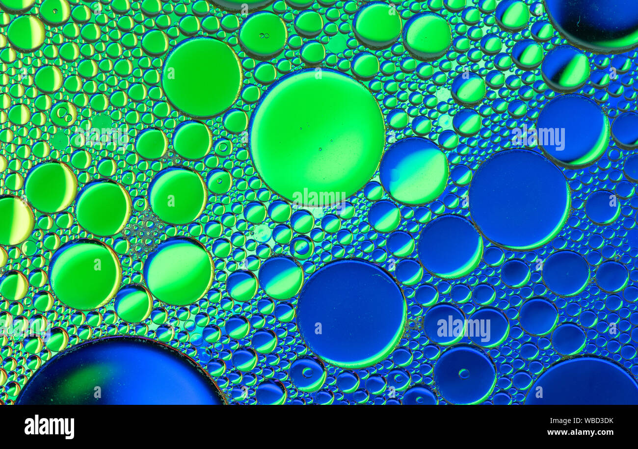 Multi-coloured bubble patterns formed by oil floating on water Stock ...