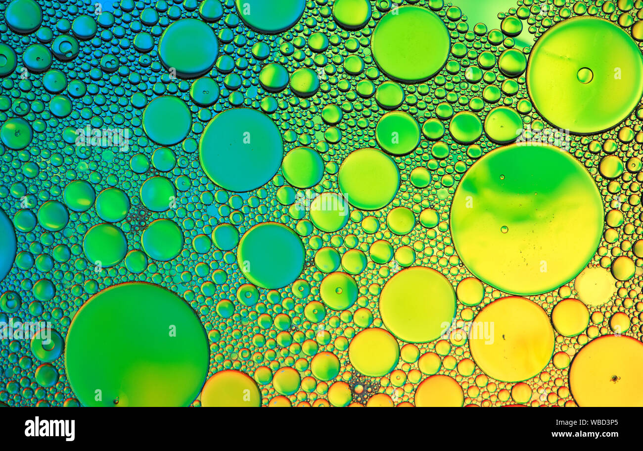 Multi-coloured bubble patterns formed by oil floating on water Stock ...