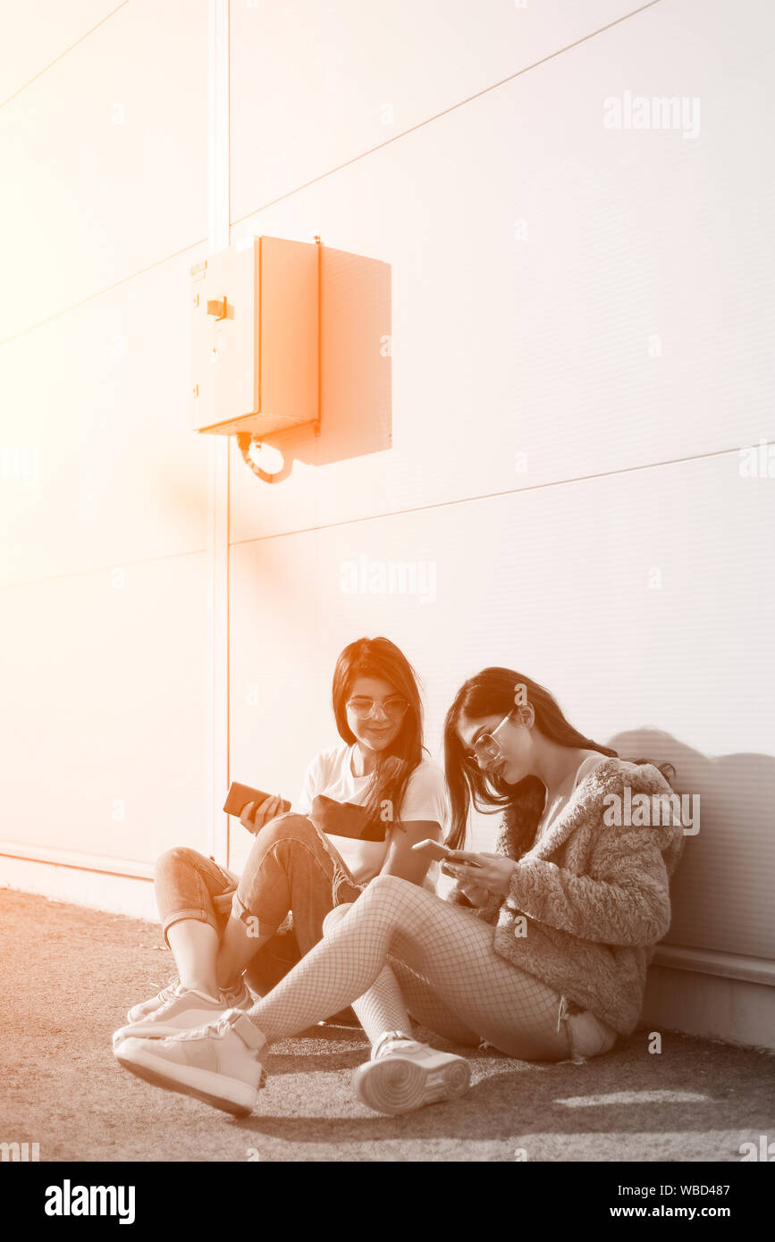 Girlfriends having fun with mobile phones hi-res stock photography and ...