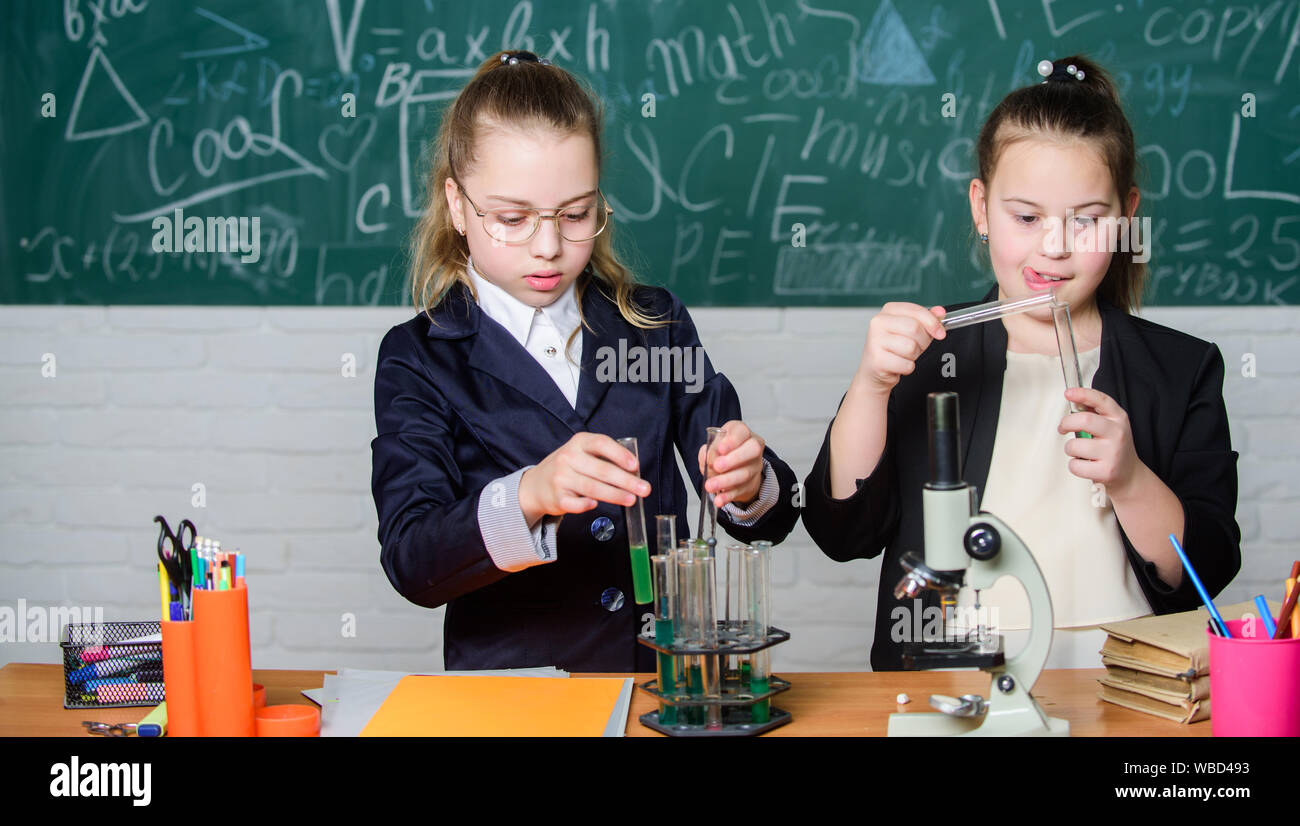 Sharing thoughts. Little girls in school lab. Teamwork. Biology lab ...