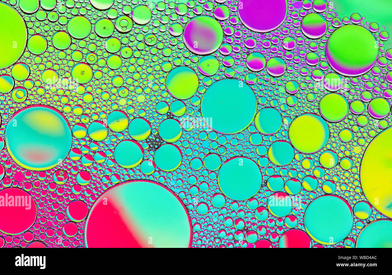 Multi-coloured bubble patterns formed by oil floating on water Stock ...
