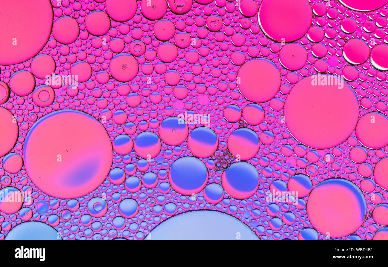 Multi-coloured bubble patterns formed by oil floating on water Stock ...