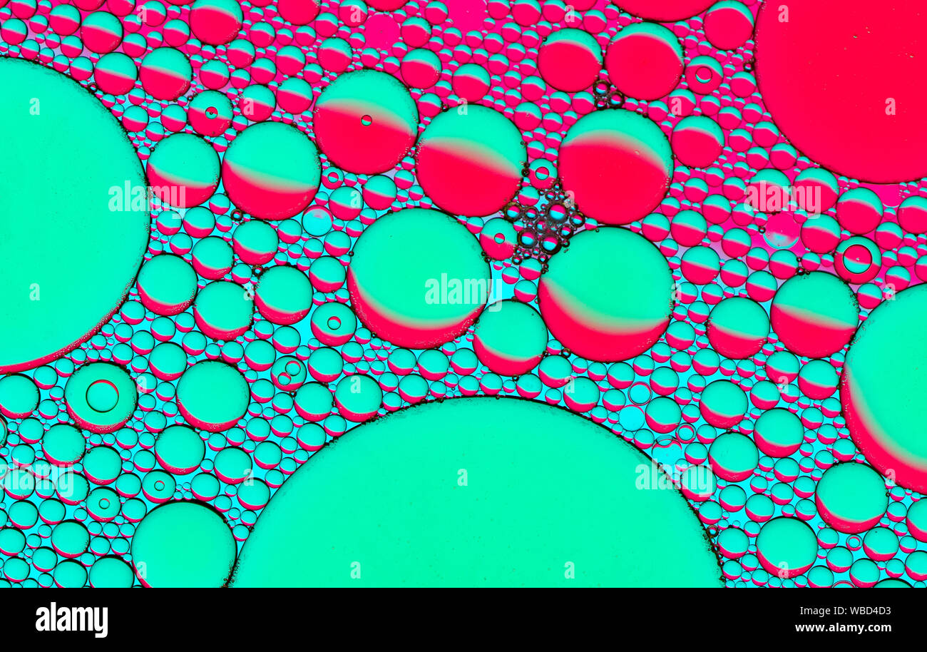 Multi-coloured bubble patterns formed by oil floating on water Stock ...
