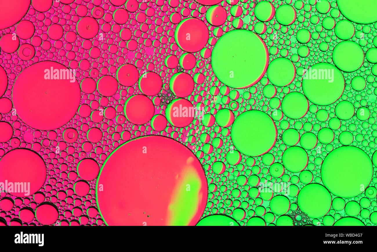 Multi-coloured bubble patterns formed by oil floating on water Stock ...