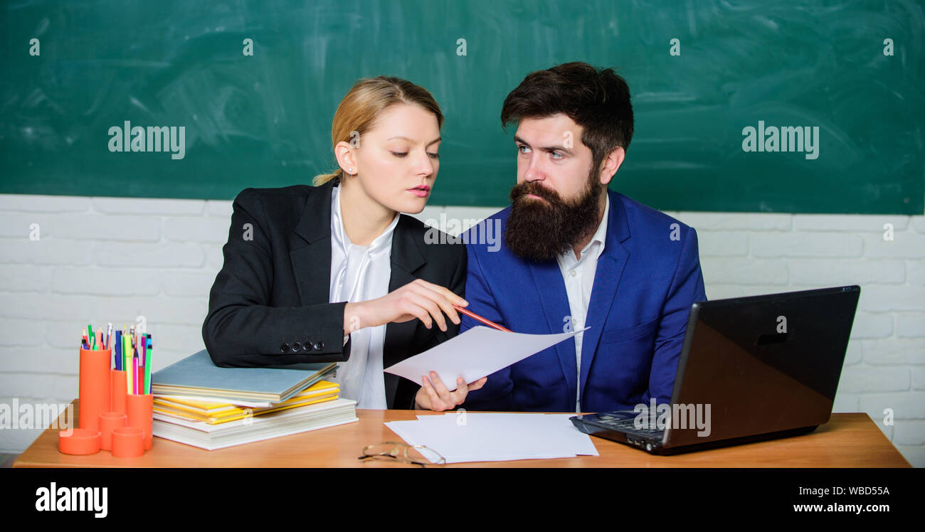 School educator with laptop and principal with official documents ...