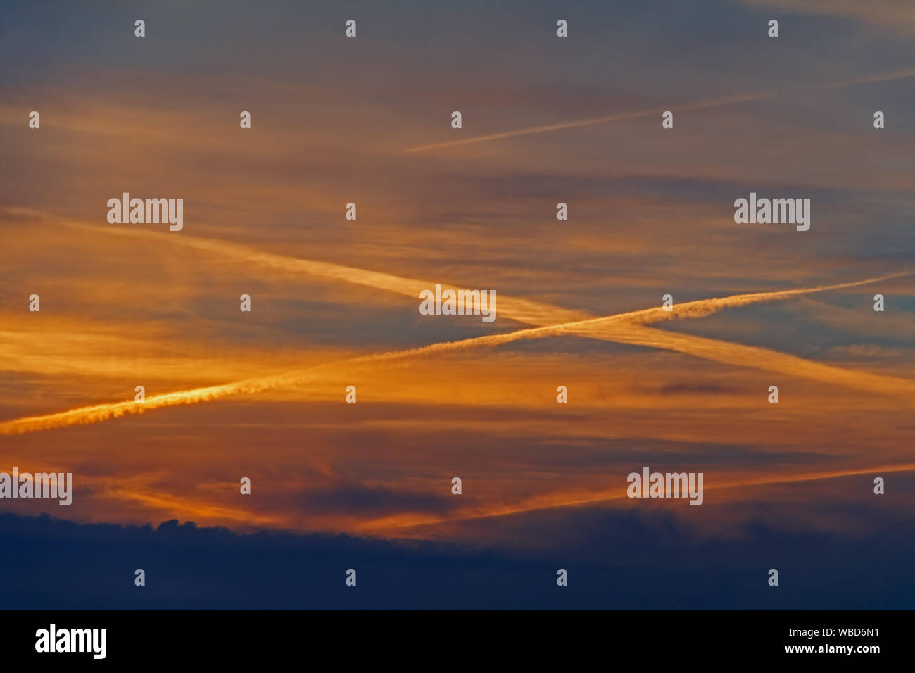 Blue sky with contrails crossing hi-res stock photography and images ...