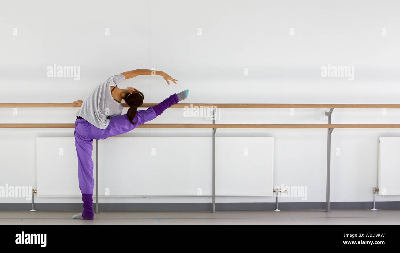 young ballerina stretching at the barre Stock Photo - Alamy