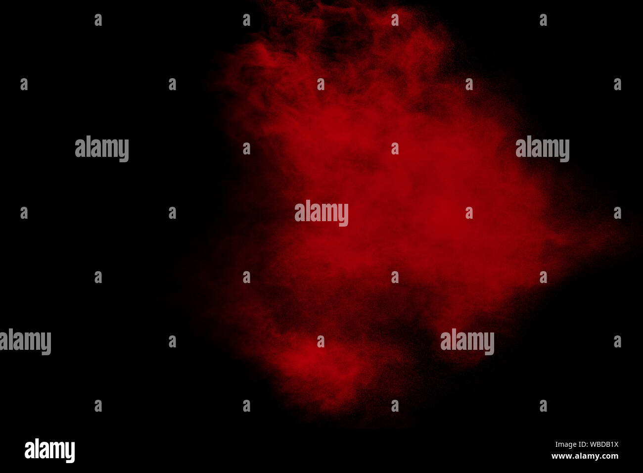 Red color powder explosion on black background.Freeze motion of red ...