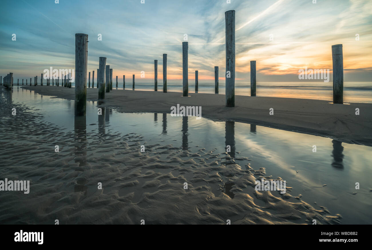 Wooden posts shore sky sunset beach hi-res stock photography and images ...