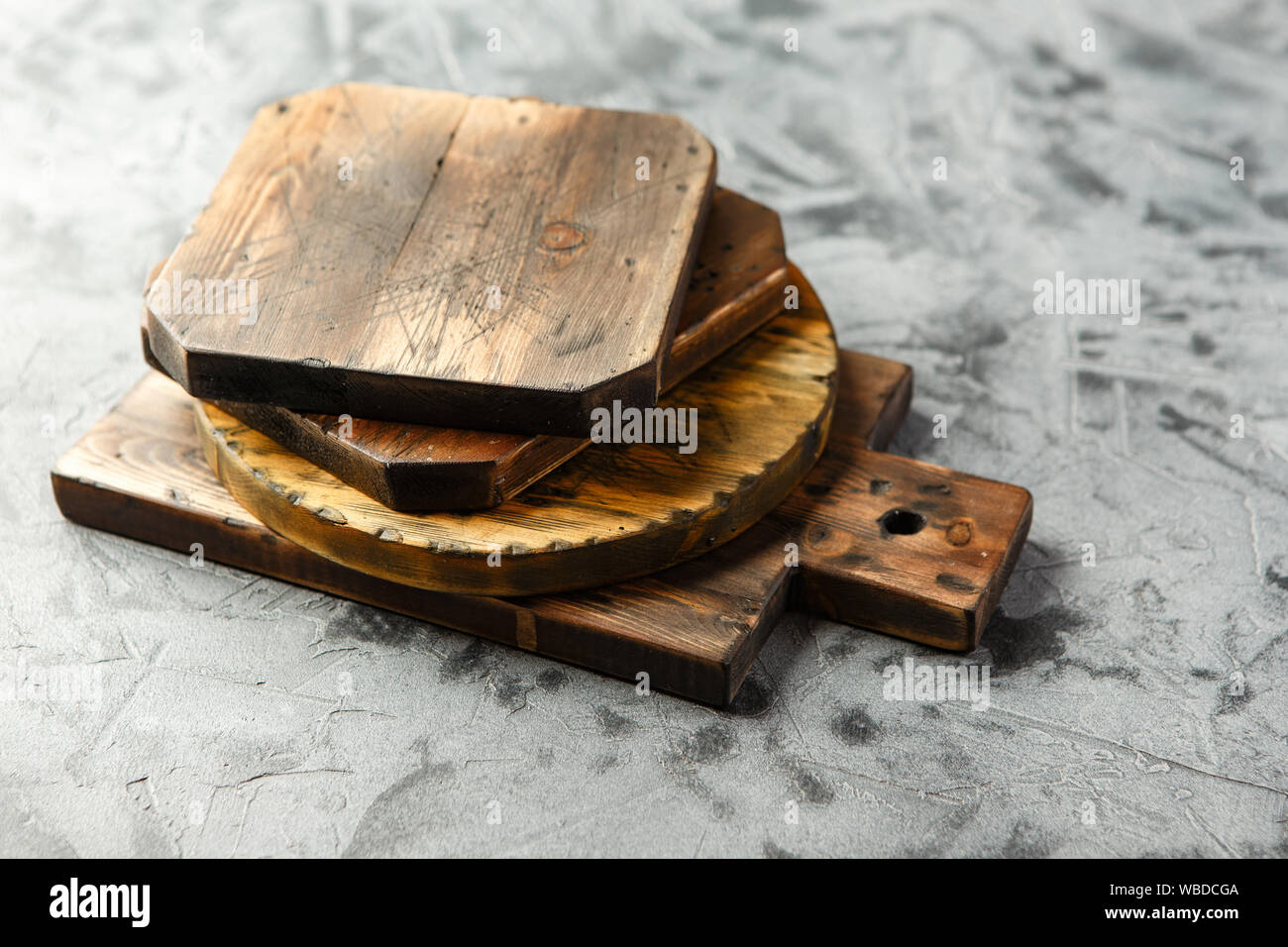 Stack of different wooden cutting boards on grey background Stock Photo ...